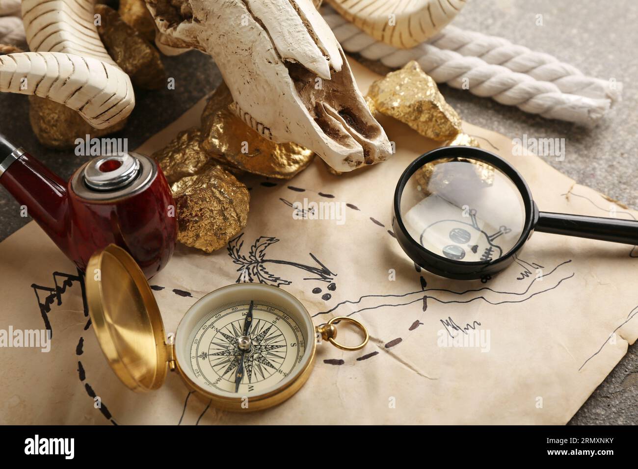 Sheep scull with travel equipment, smoking pipe and golden nuggets on ...