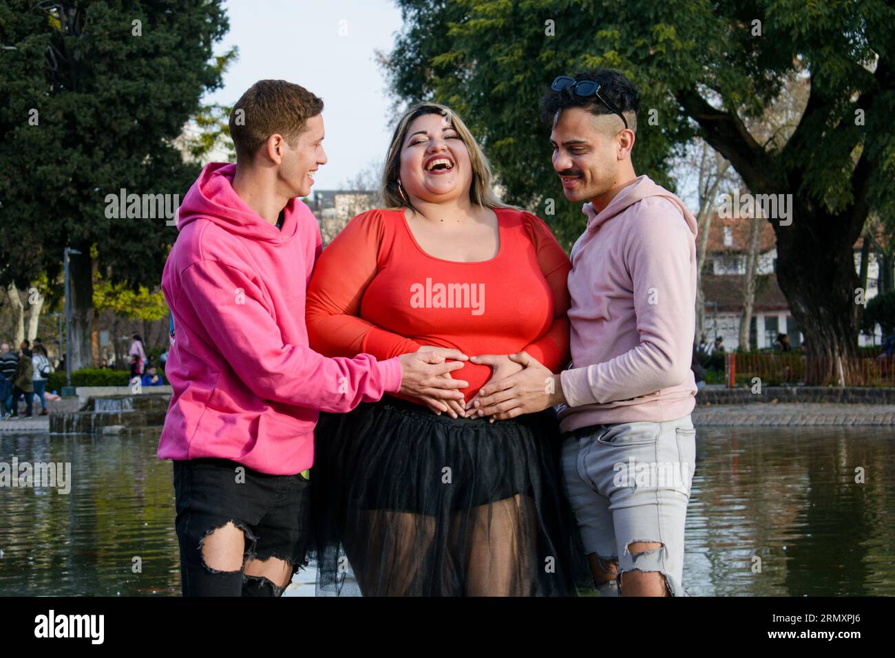 three friends laughing and playing with each other, having fun and ...