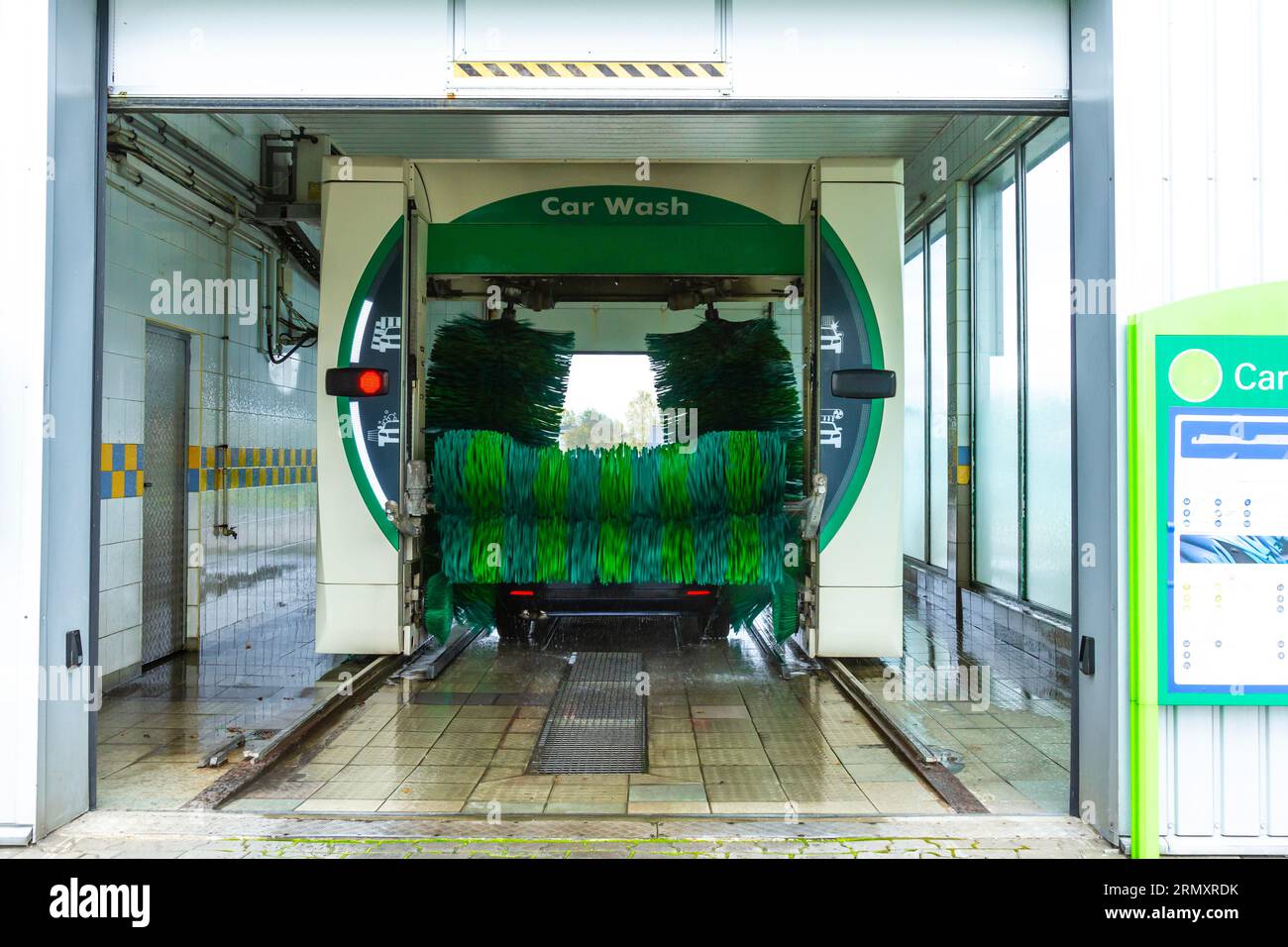 An automatic car wash with a passenger car in the process of getting ...