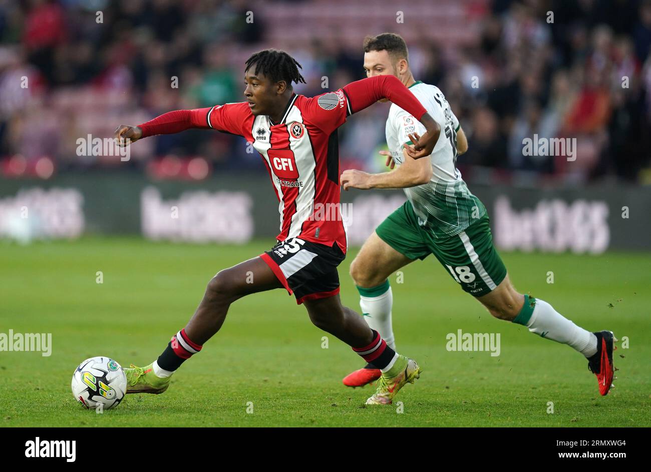 Sheffield United's Andre Brooks (left) and Lincoln City's Ben House ...