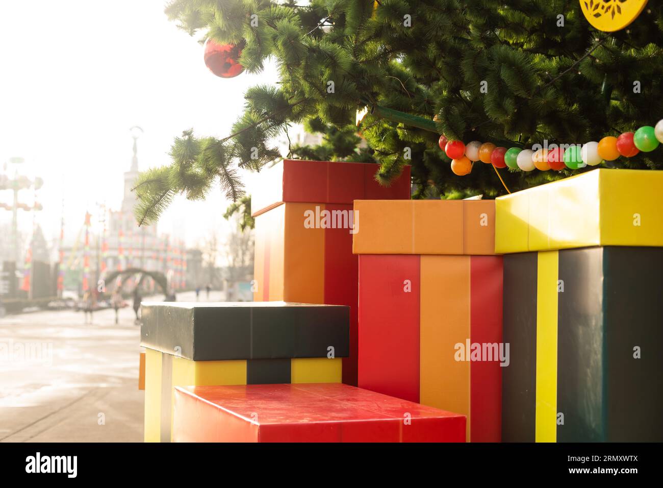 Large gift boxes with bows in the town square. Christmas street decor ...