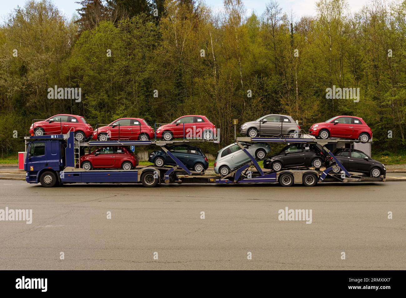 Car transporter with new cars parked on the roadside. Transportation of ...