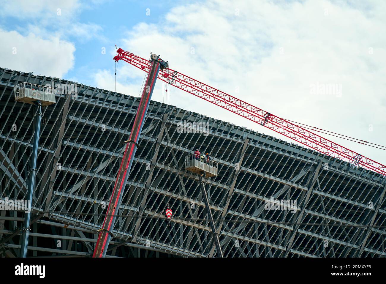 workers at the car tower work at a height Stock Photo - Alamy