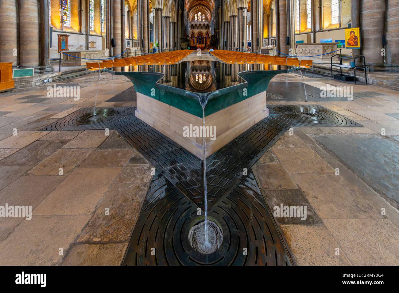 The font water feature reflects the altar and interior of the medieval ...