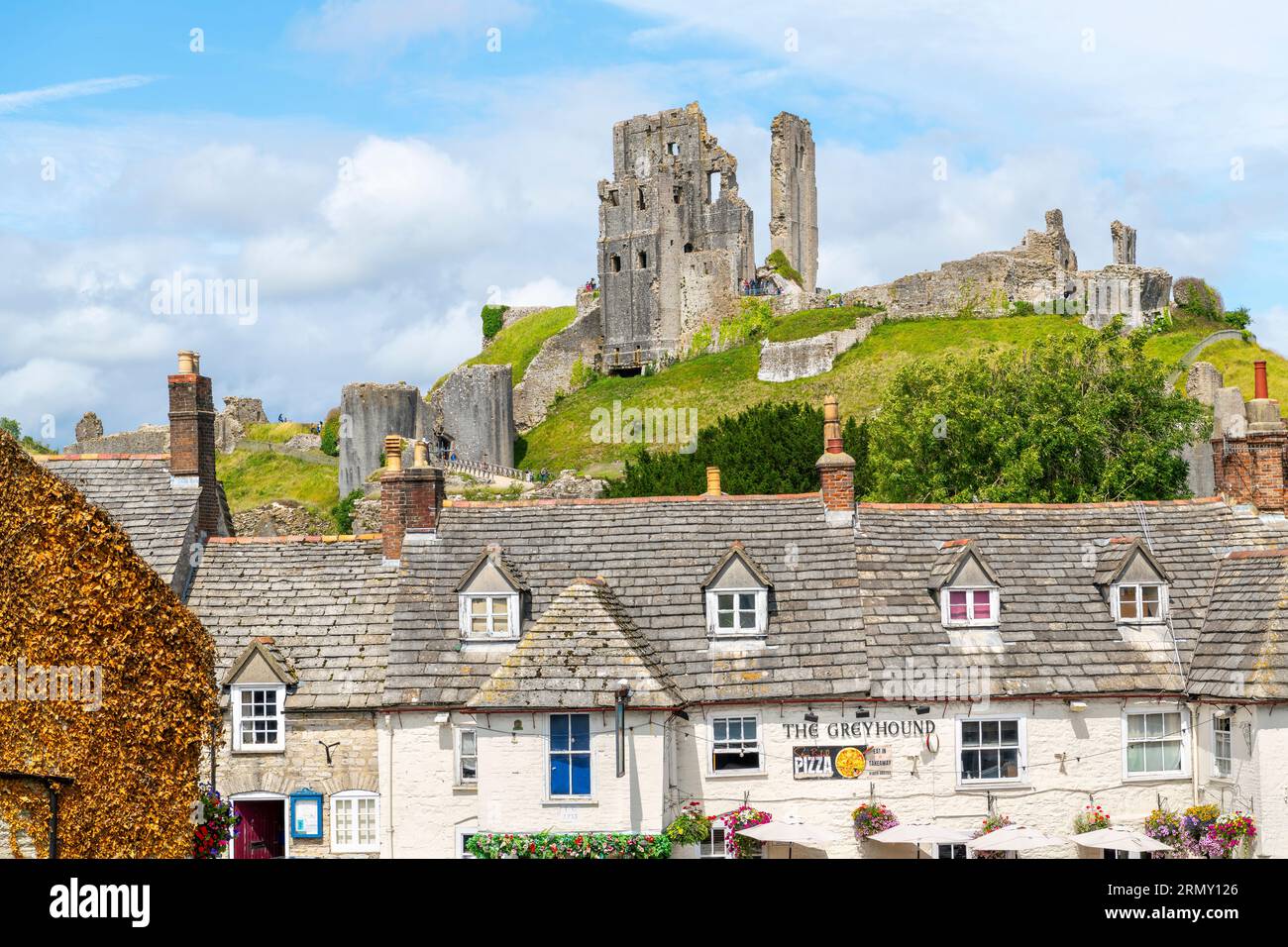 The imposing ruins of the medieval hilltop Corfe Castle, seen above the ...