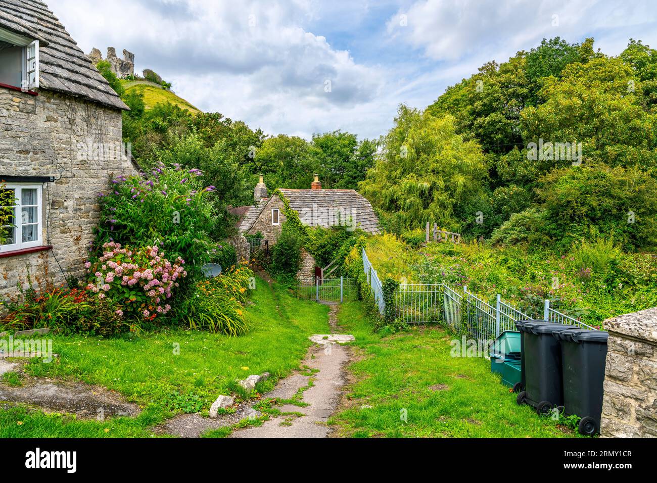 A picturesque stone cottage alongside a water mill and waterfall in the ...