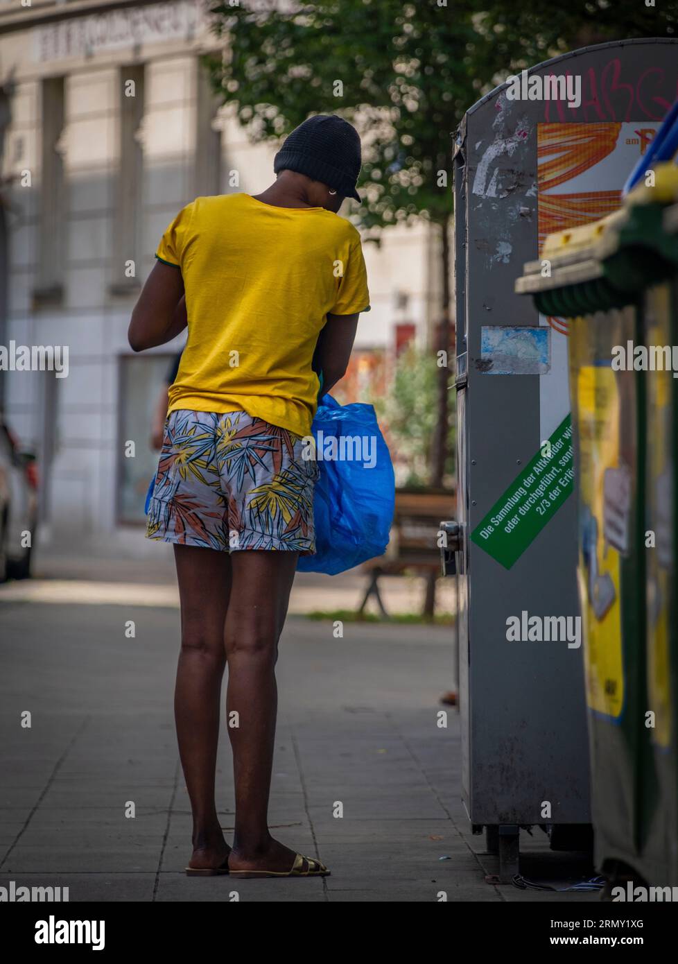 Black woman sorting garbage near dustbin in Wien morning streets Stock ...