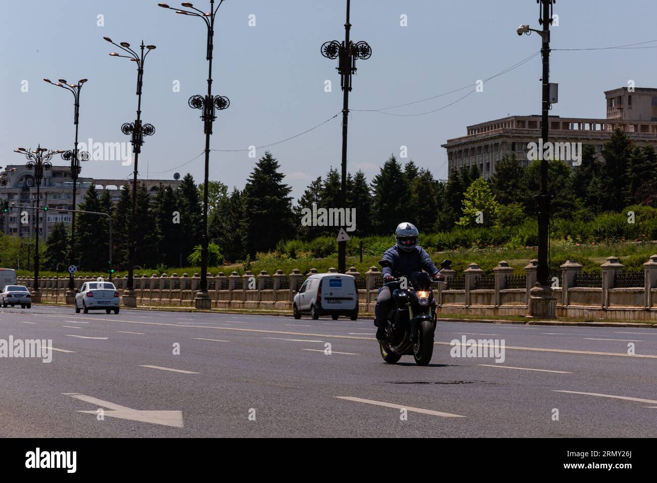 Biker on a motorcycle in traffic at rush hour in downtown area of the ...