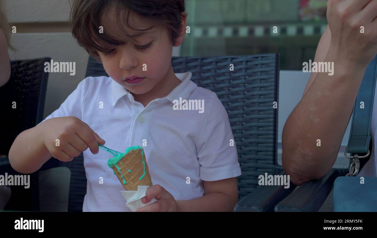 Little Boy Savoring Blue Ice-Cream Cone with Spoon, child eating ...