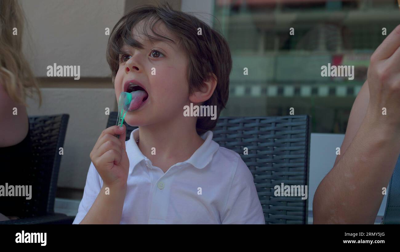 Little Boy Savoring Blue Ice-Cream Cone with Spoon, child eating ...