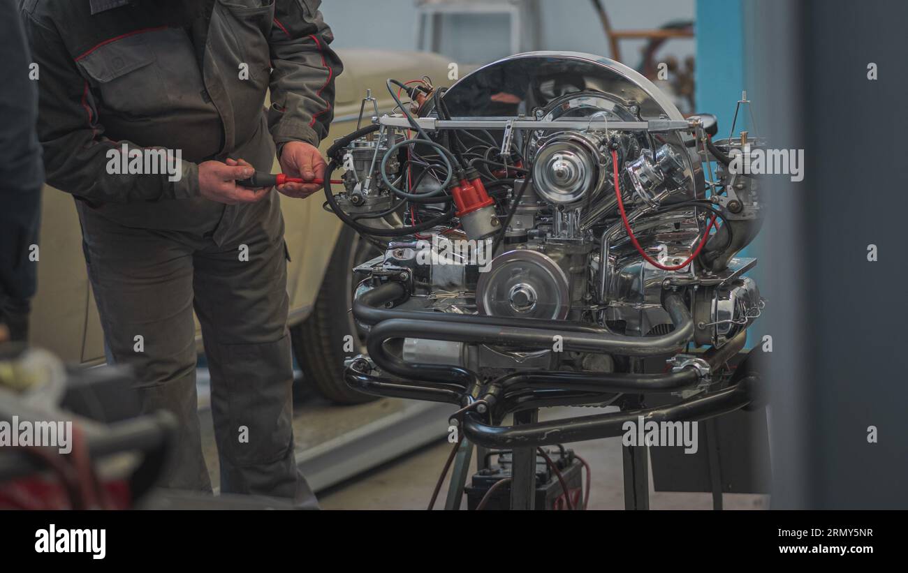 Hands of a mechanic are visible adjusting or setting idle or air ...