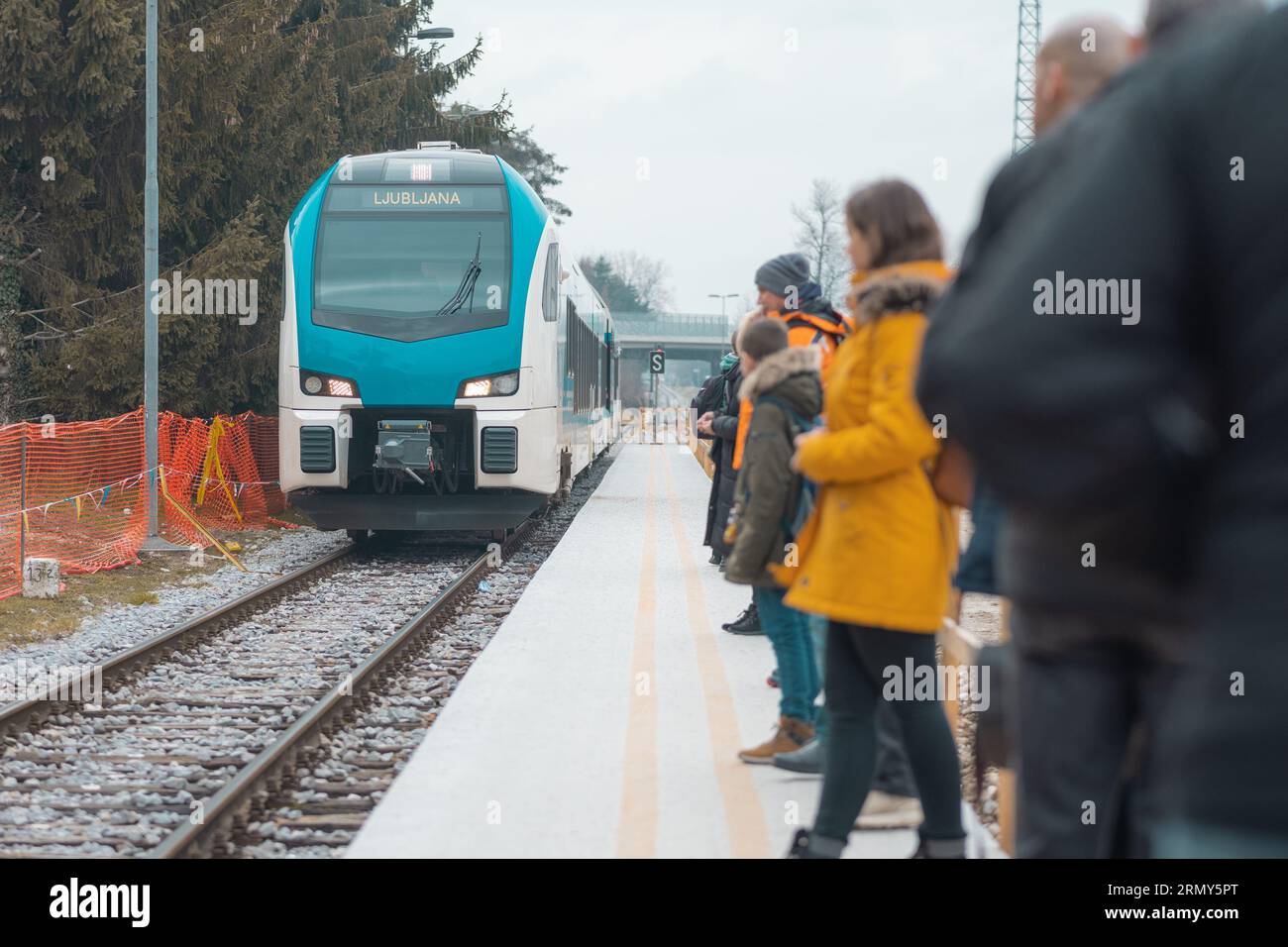 Modern train arriving to the station of Domzale which is being ...