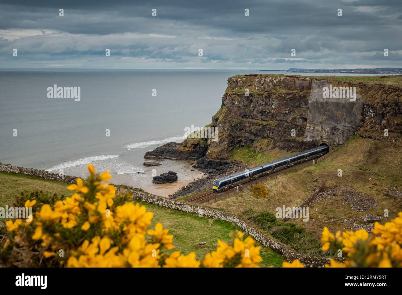 Beautiful stretch of North ireland rail between two tunnels and beach ...