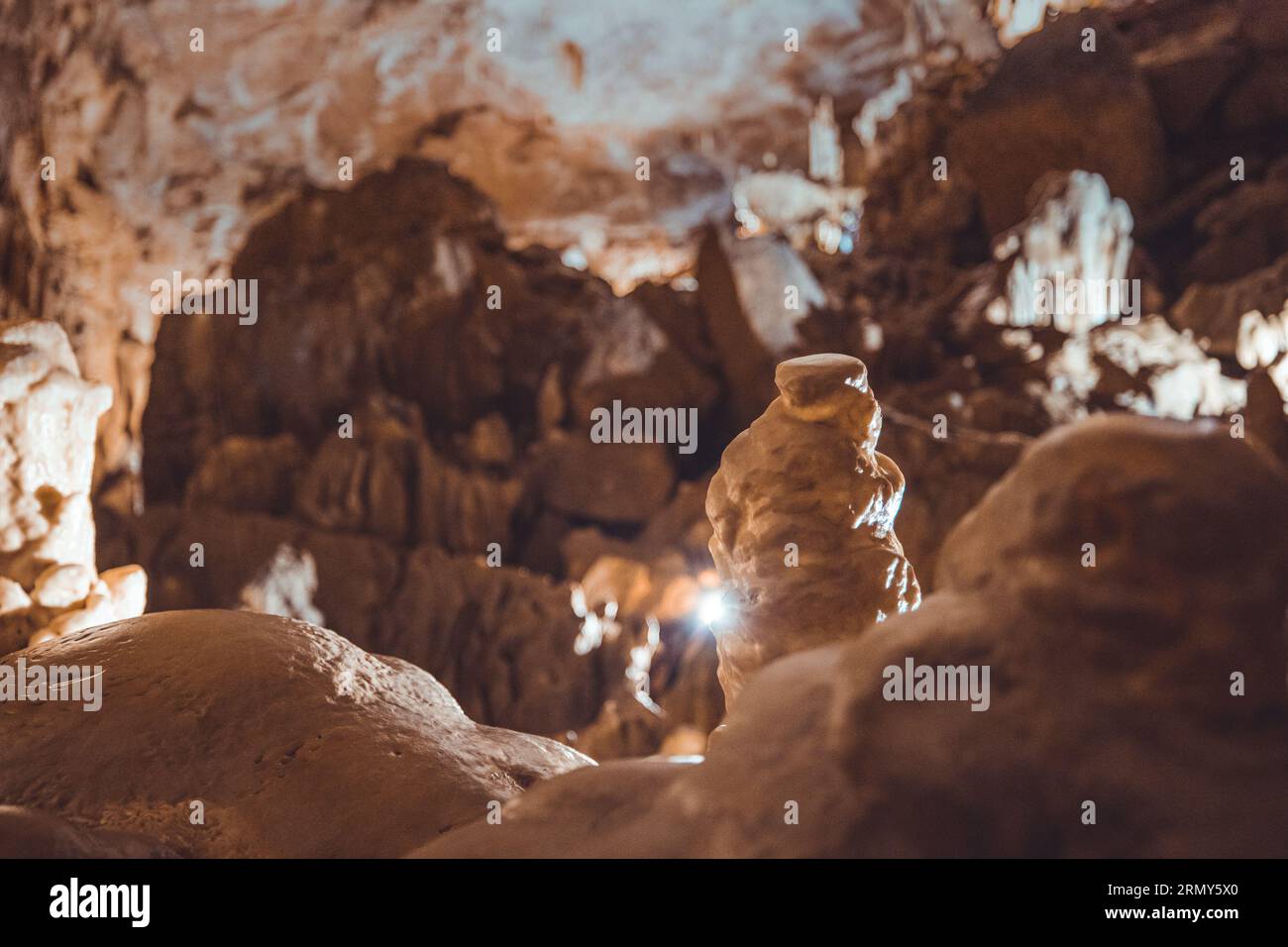 Cave filled with stalactites and stalagmites forming pillars and other ...