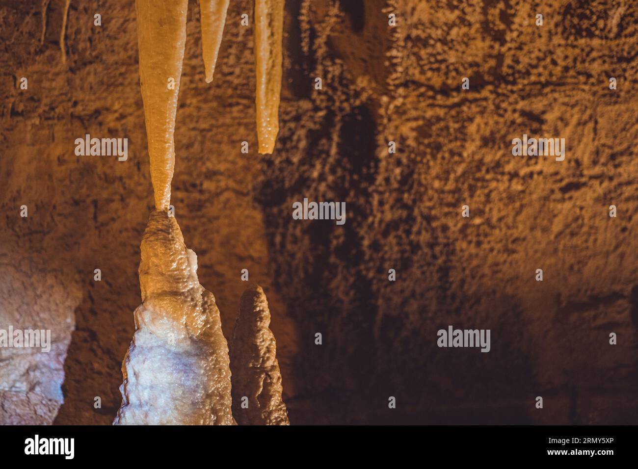 Cave filled with stalactites and stalagmites forming pillars and other ...