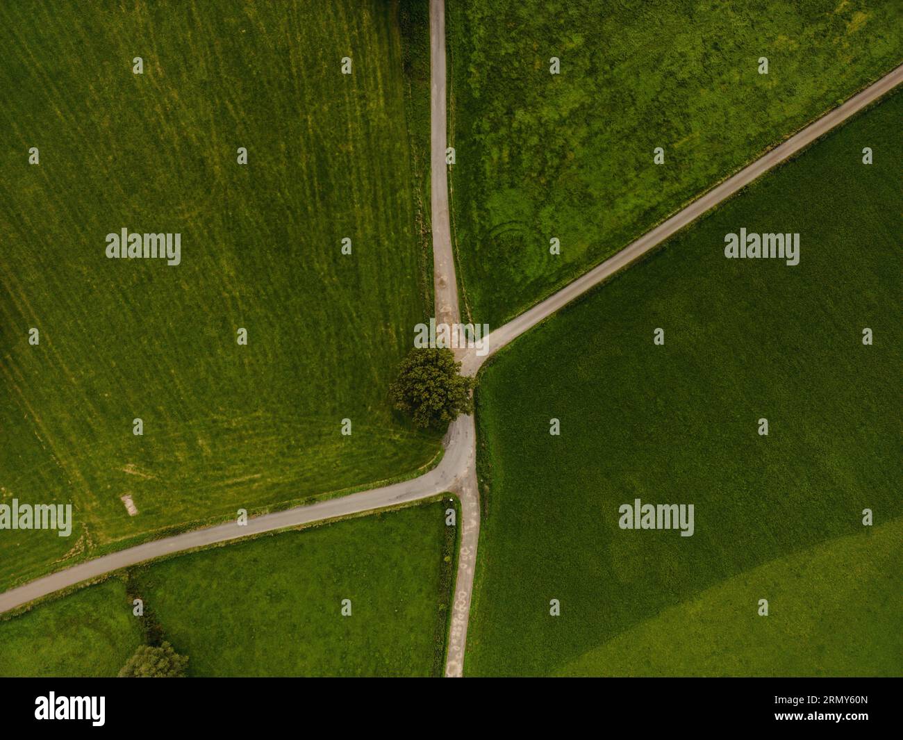 Aerial view of a four-way intersection on an expanse of green grass in ...