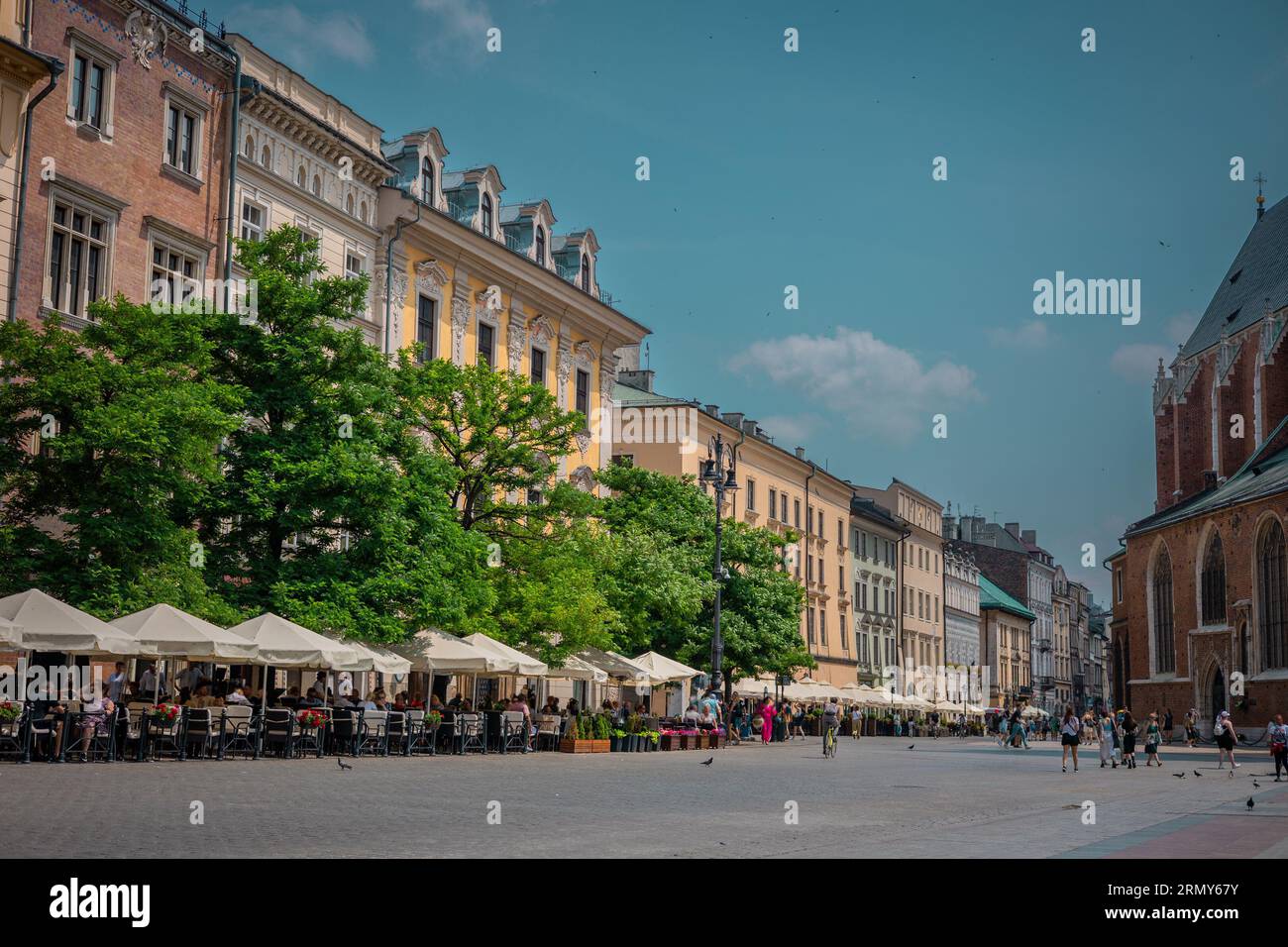 Bars and restaurants on famous old square in Krakow city on a hot ...