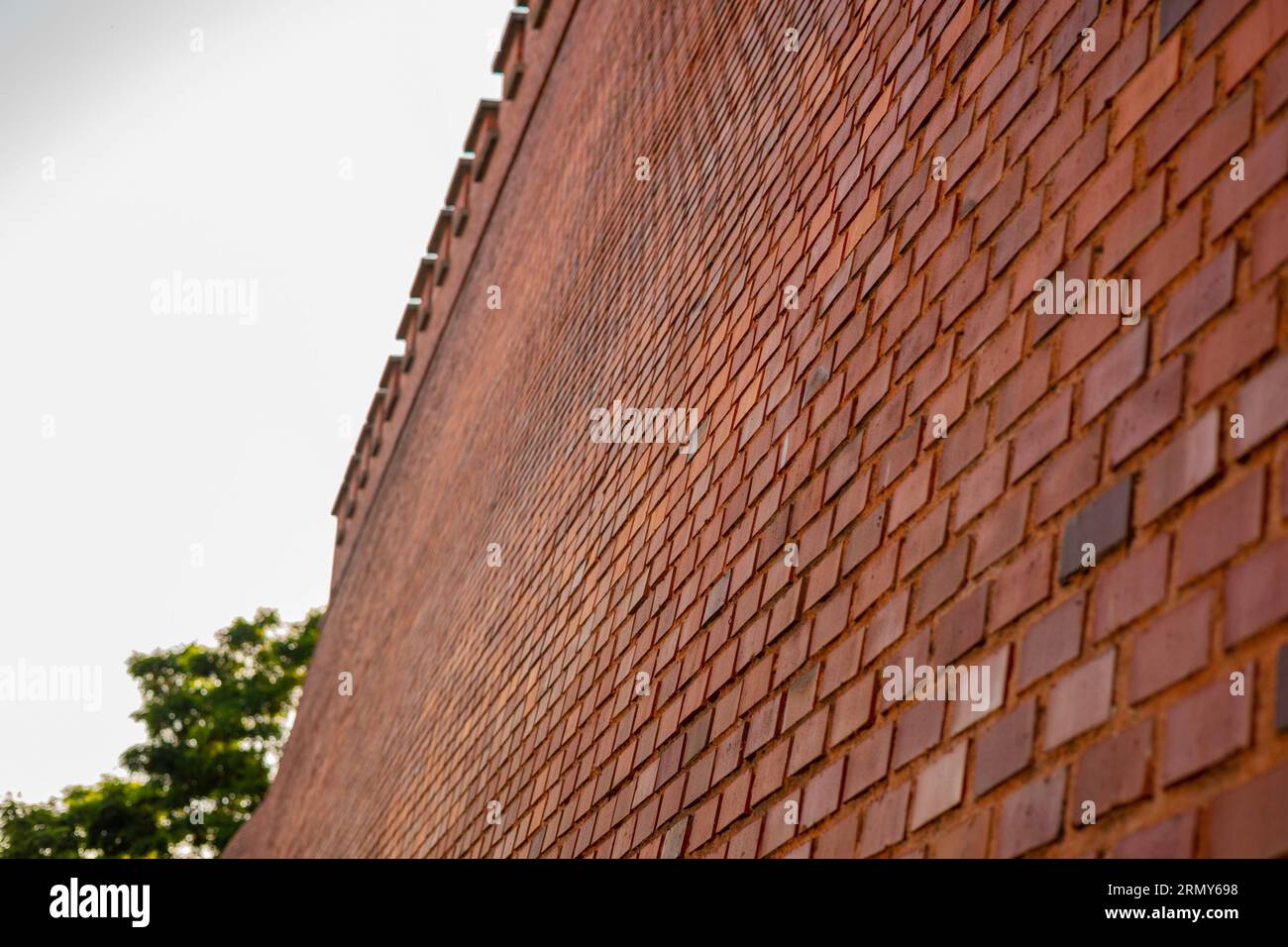 Big brick wall made of orange and red bricks as part of outer wall of ...