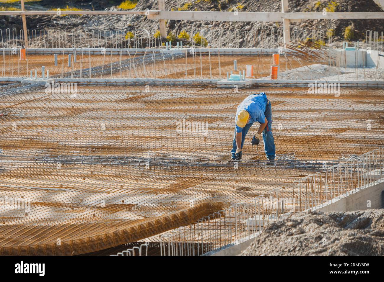 Overview of construction worker using pincers and fixing steel rebar or ...