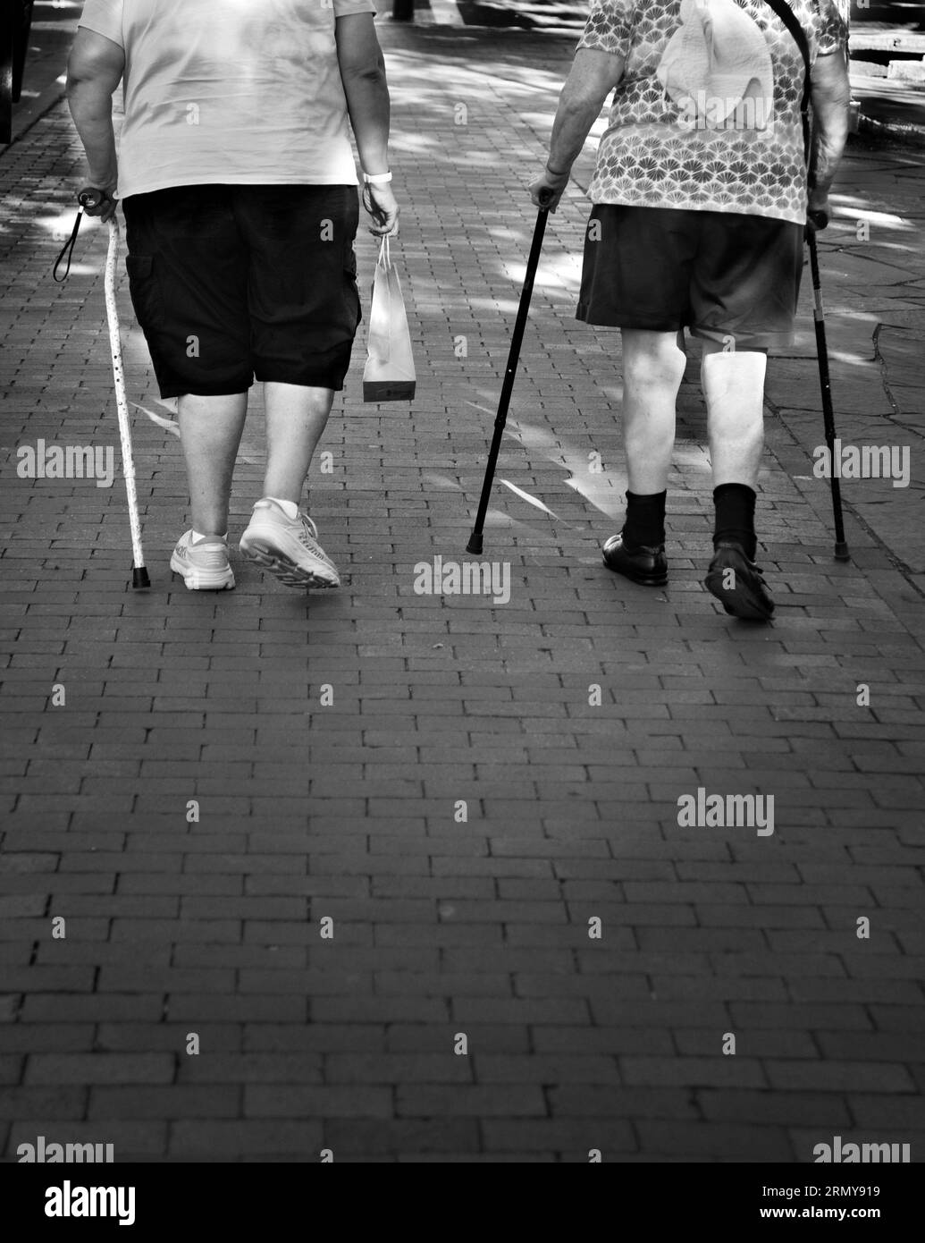 Two elderly women walk with canes along a sidewalk in Santa Fe, New ...