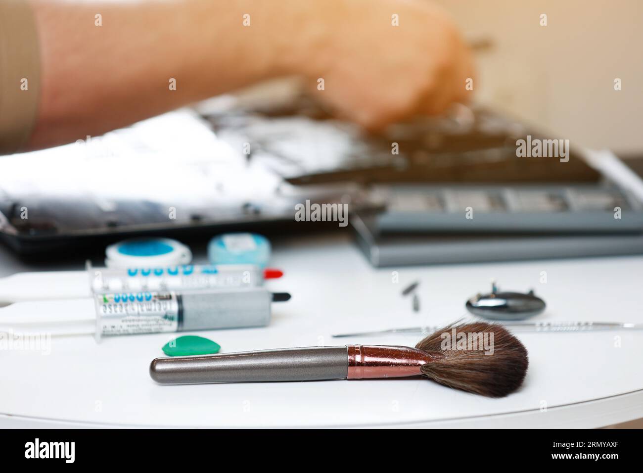 Cleaning brush and dusty laptop cooling fan on white background. Air ...