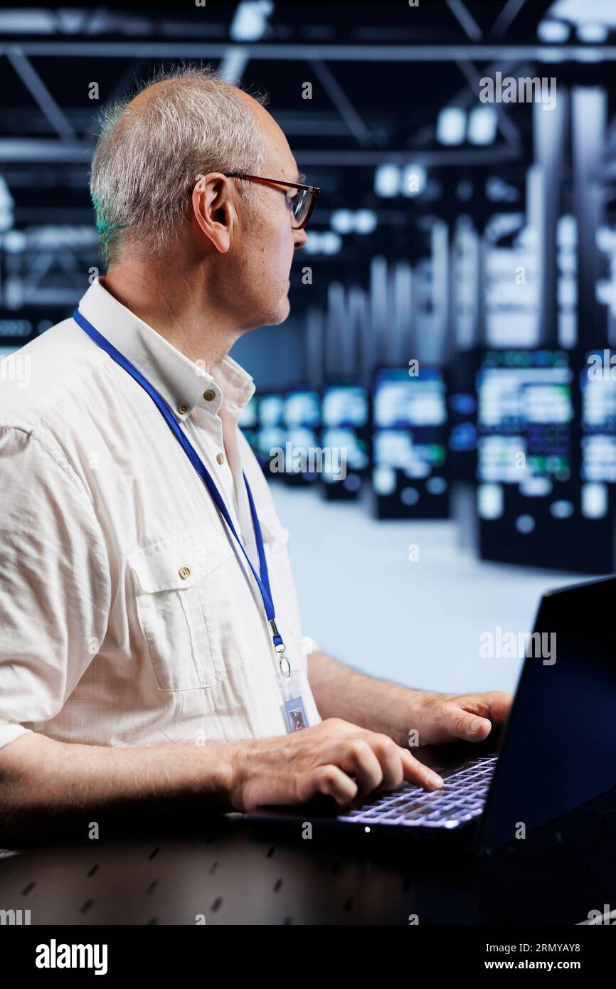 Old certified IT programmer in data center providing dedicated VPN ...