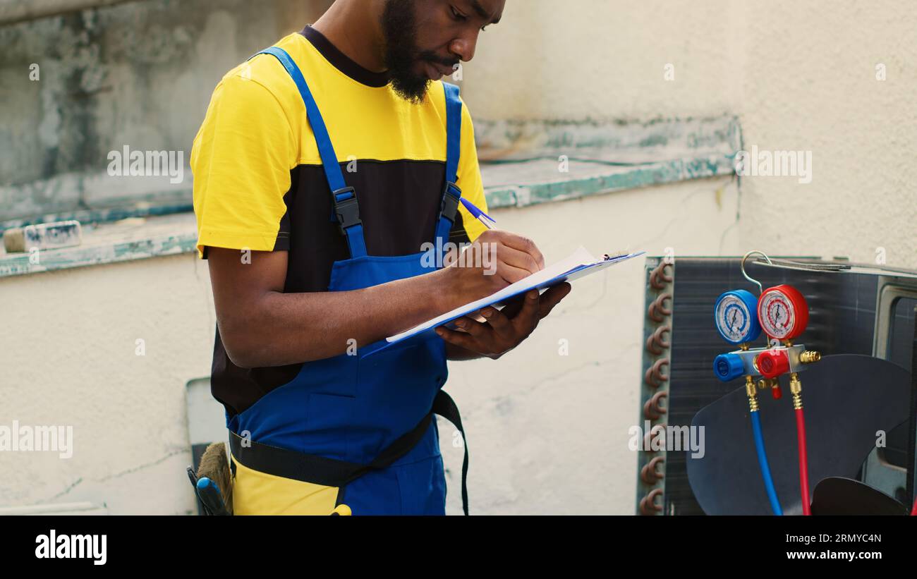 Qualified technician doing inspection of refrigerant levels and ...