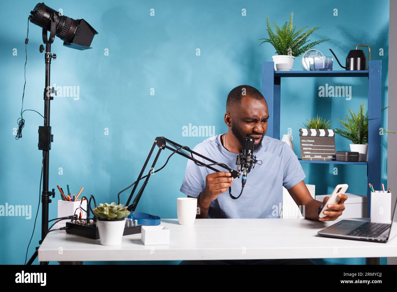 African man reading into microphone hi-res stock photography and images ...