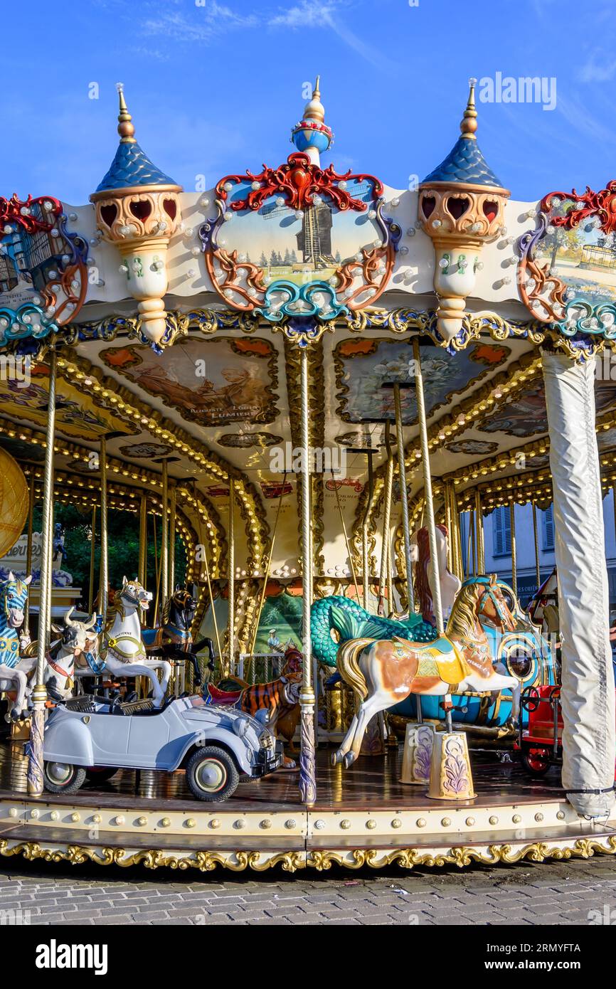Colorful traditional old french caroussel in city park in sunny day ...