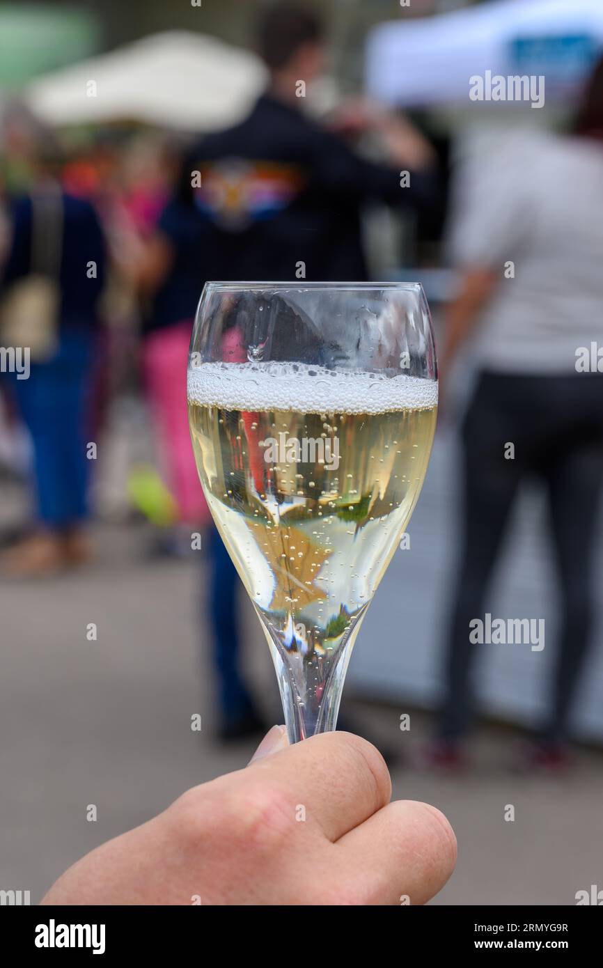 Tasting of sparkling white wine with bubbles champagne on summer ...