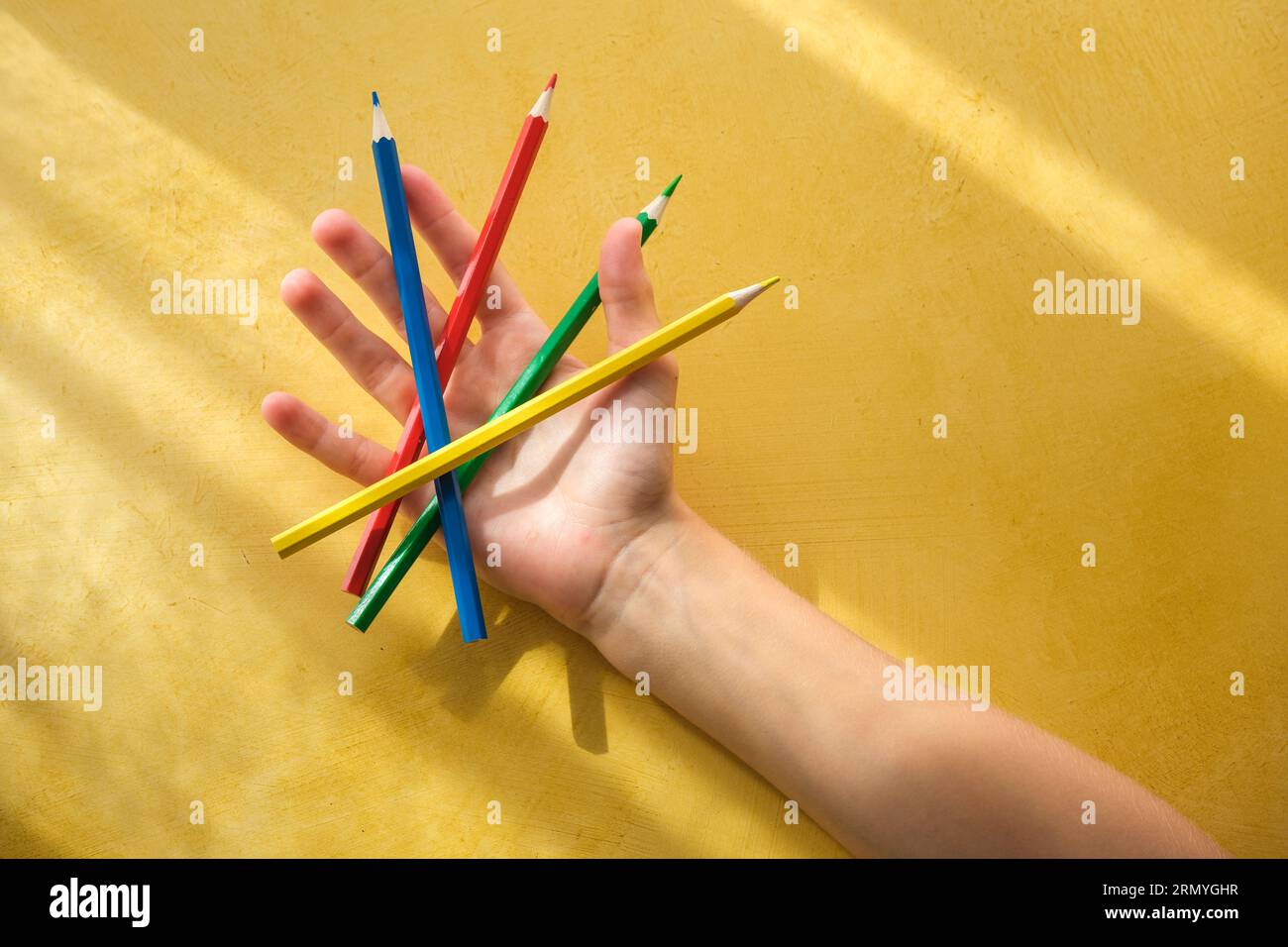 Black child's hand with pen hi-res stock photography and images - Alamy