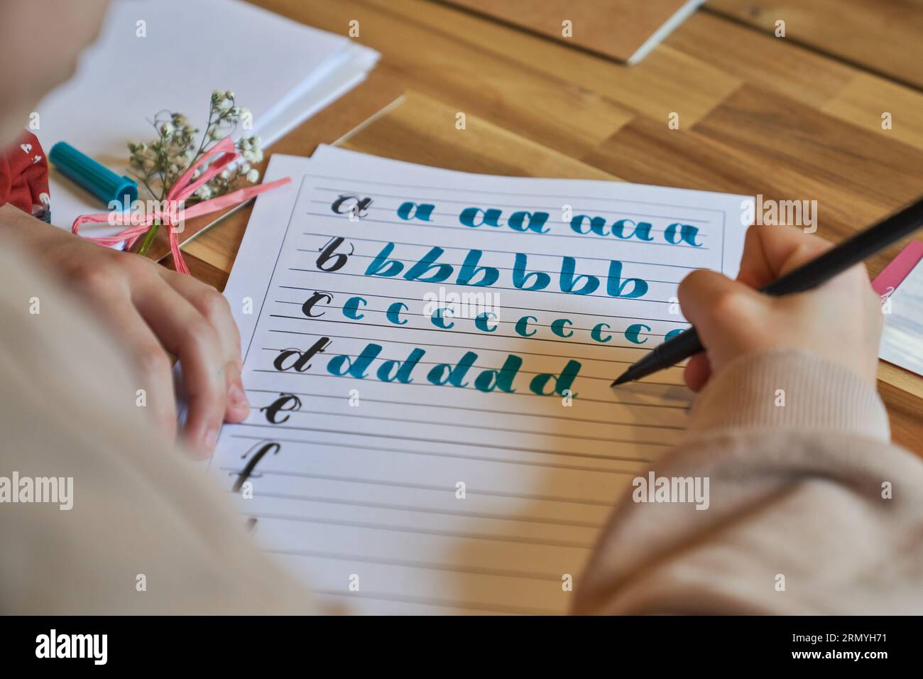From above of unrecognizable artist learning art of lettering drawing ...