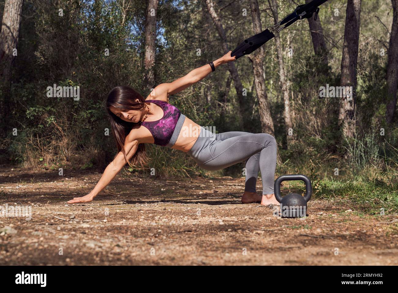 Side view of fit female athlete in activewear training on walkway in ...