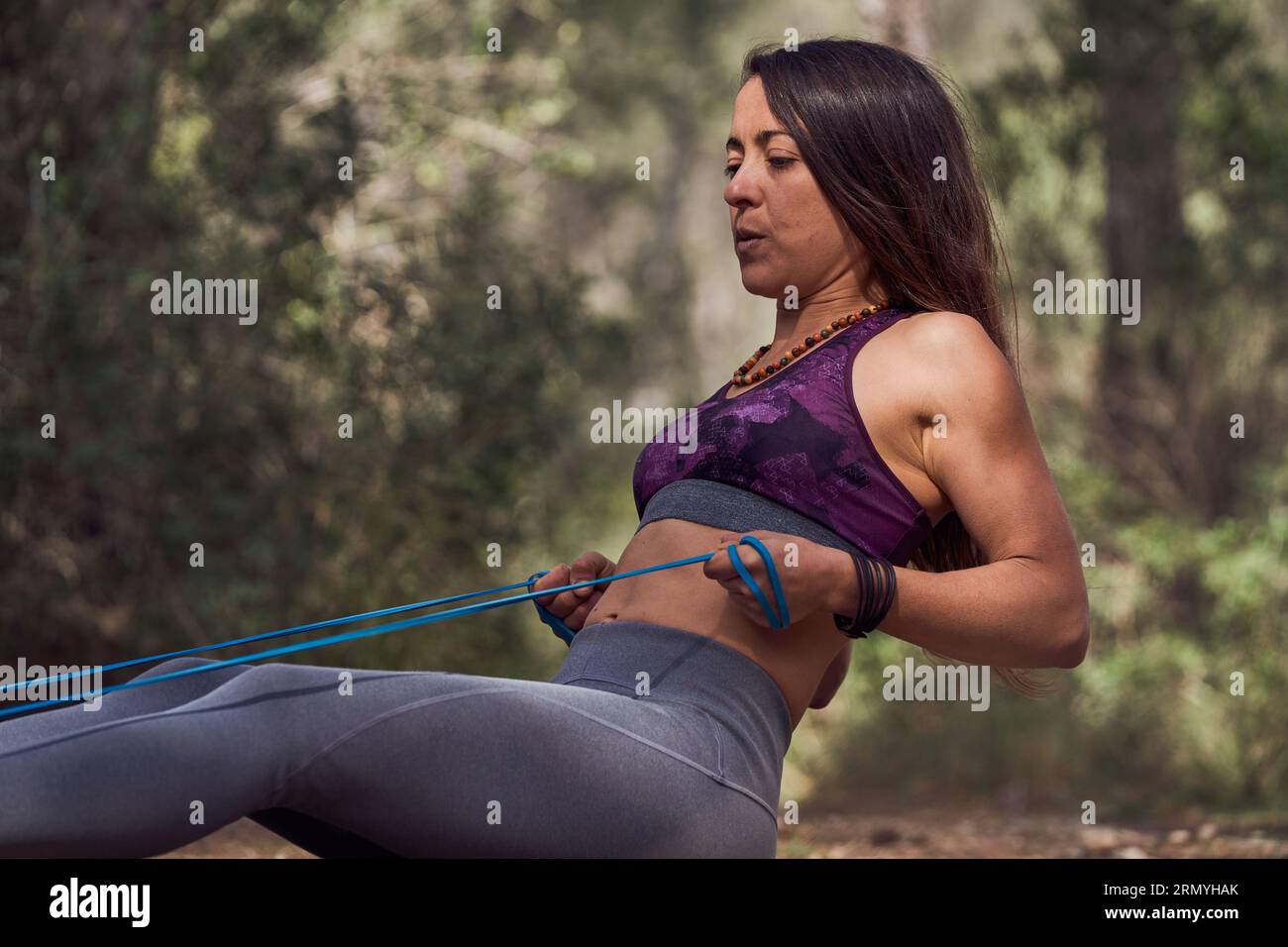 Side view of determined young fit Hispanic female athlete with long ...