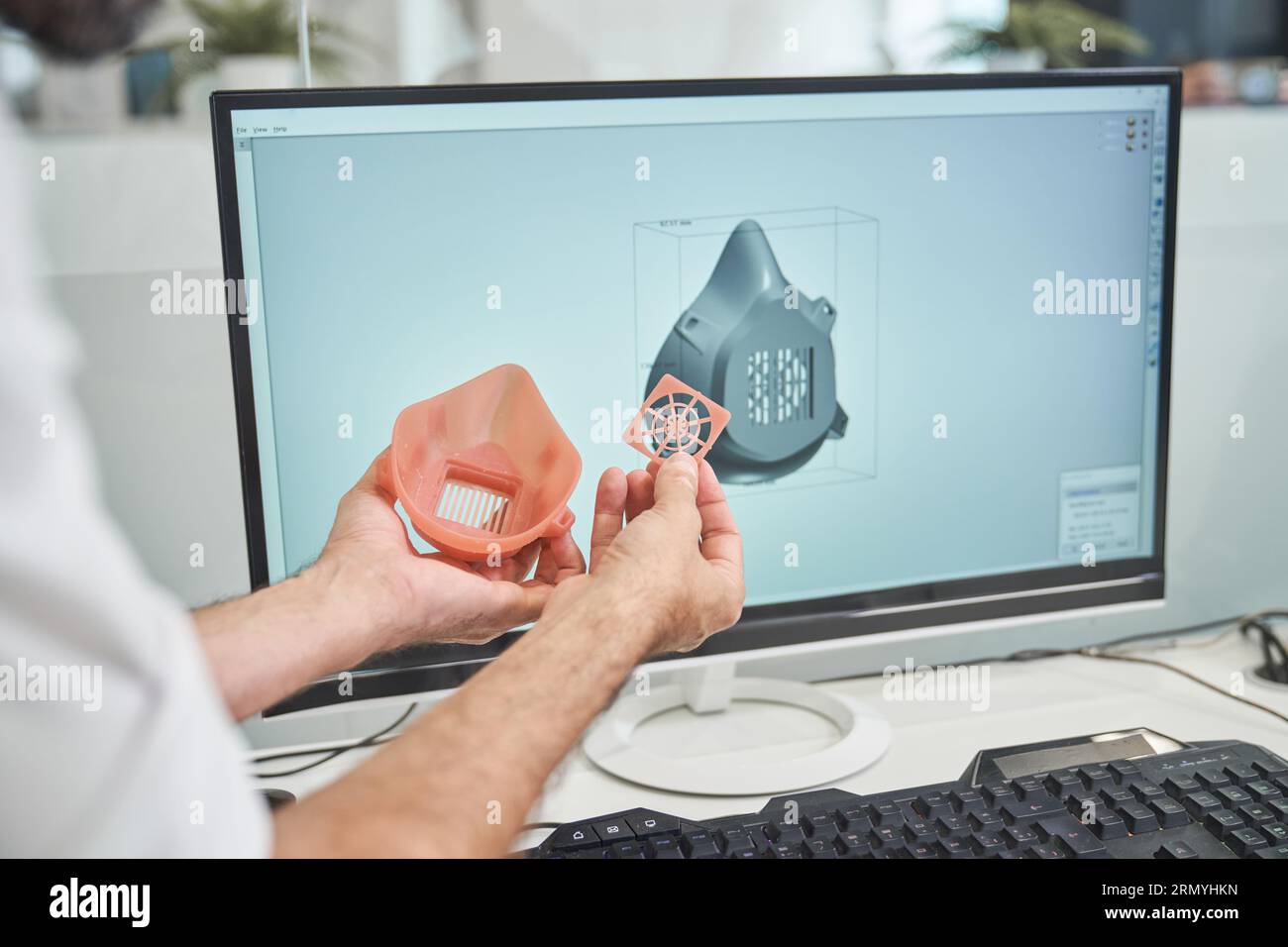 Crop unrecognizable worker with printed respirator with filter standing ...