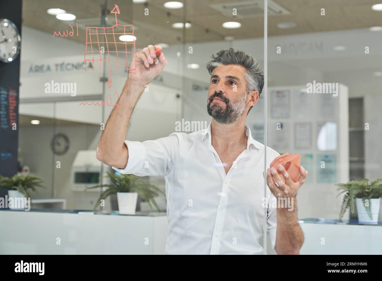Through window of professional engineer with model of face mask writing ...