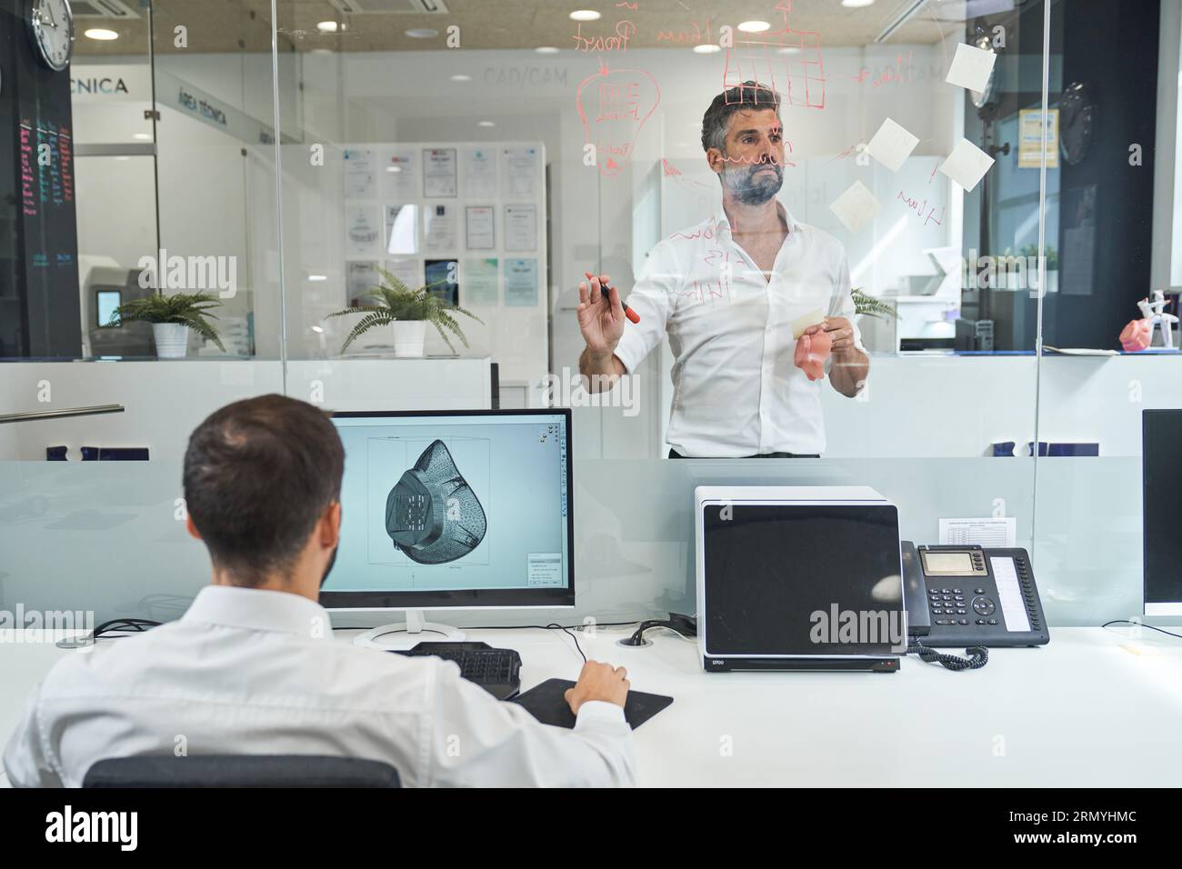 Back view of anonymous man using computer and making graphic model of ...