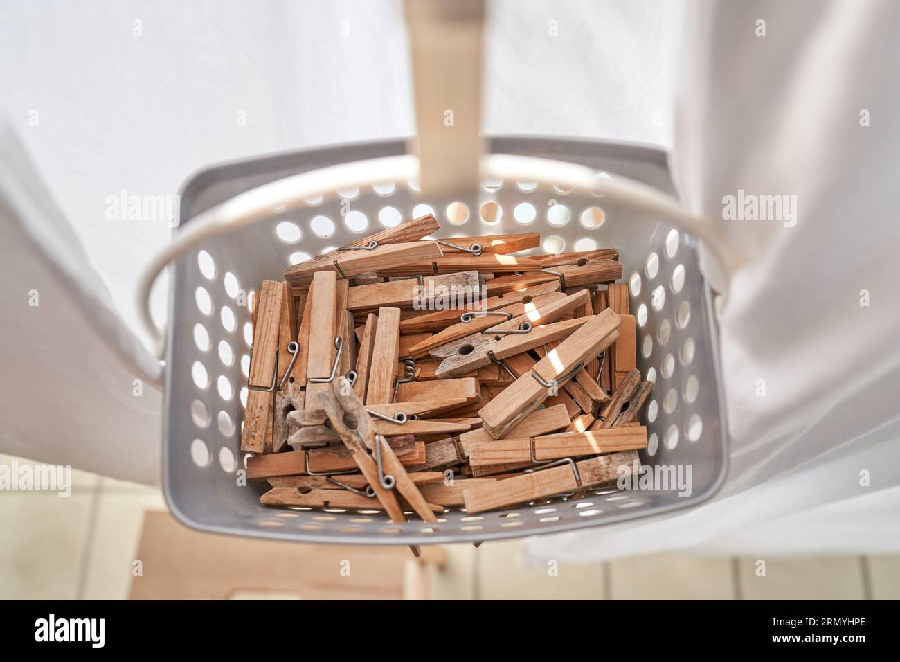 Top view of plastic basket filled with clothespins hanging from ...