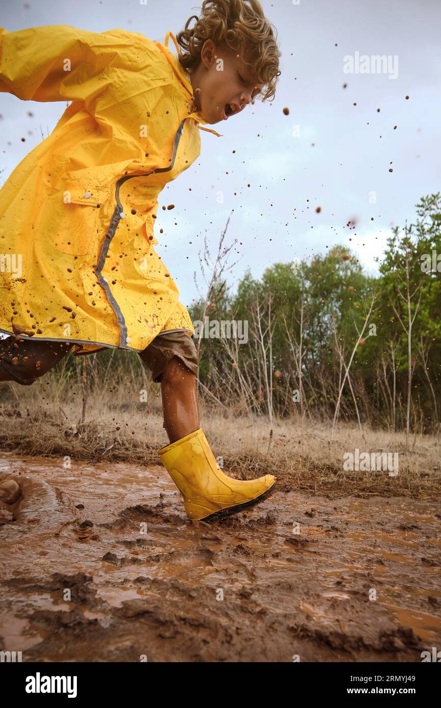 Child run through rain puddle hi-res stock photography and images - Alamy