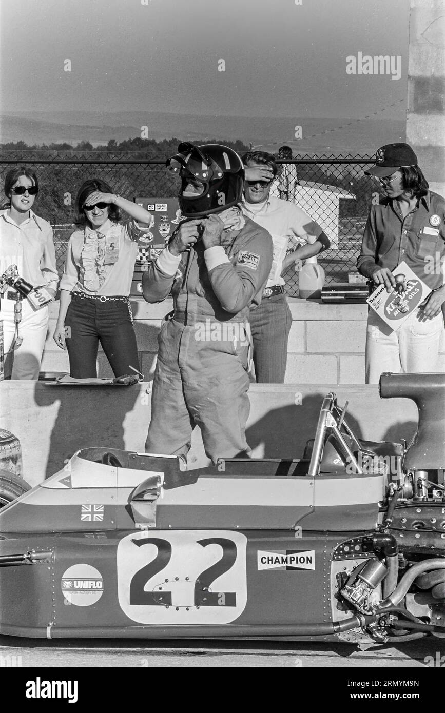 Graham Hill putting on helmet driving a Brabham BT34 at the 1971 ...