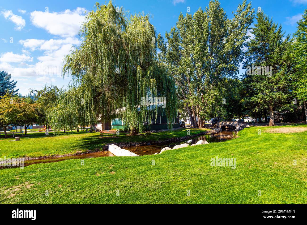 The scenic City Park with stream running through it in the rural town ...