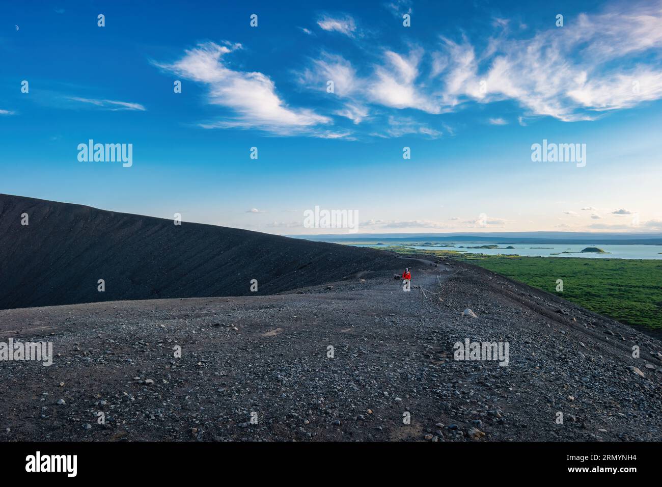 Person hikes on the Hverfjall Volcano Trail, on the rim of the crater ...