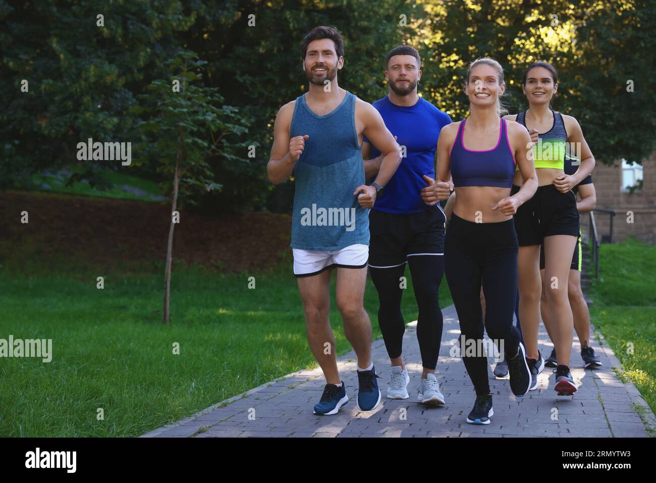 Group of people running in park. Space for text Stock Photo - Alamy
