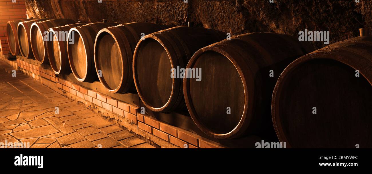 Many wooden barrels in cellar, banner design Stock Photo - Alamy