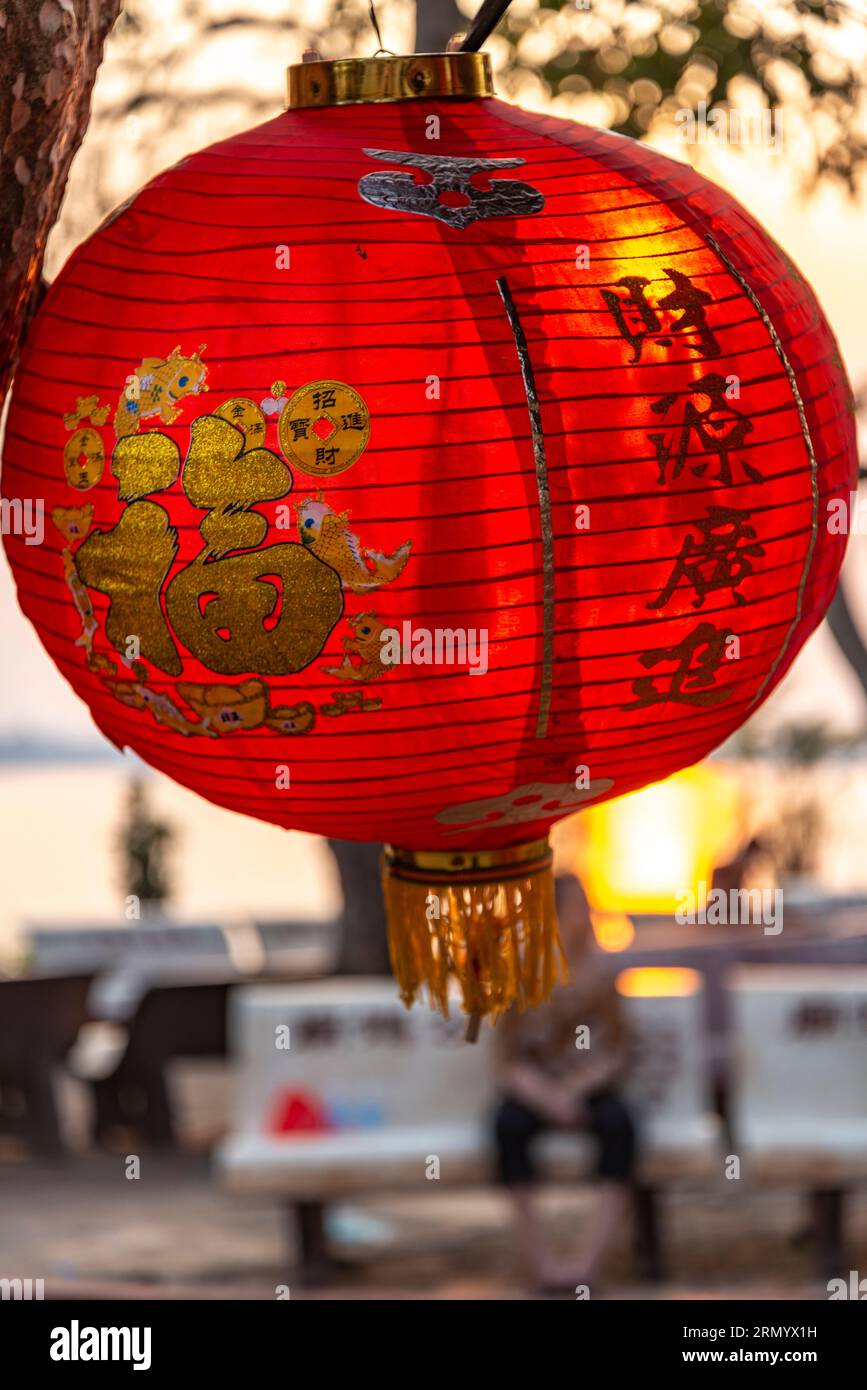 The setting sun shines through thin material of the lantern,from across ...