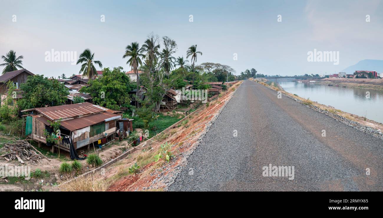 Shacks,made from wood and tin, built directly next to a narrow track ...