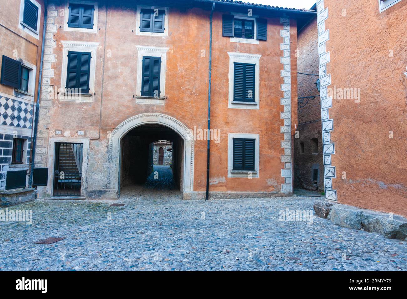 Typical European village buildings around small square of piazza with ...