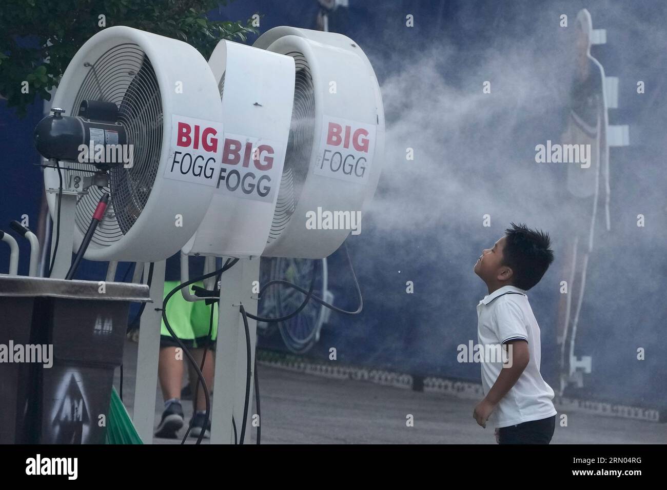Maximus Lin, 6, cools off in misting fans at the USTA Billie Jean King ...