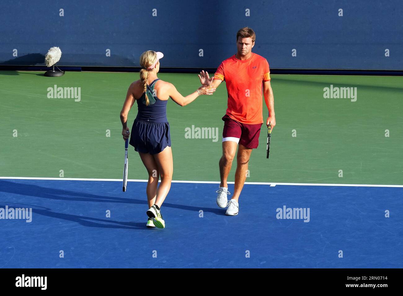 Danielle Collins and Ryan Harrison high five during a mixed doubles ...