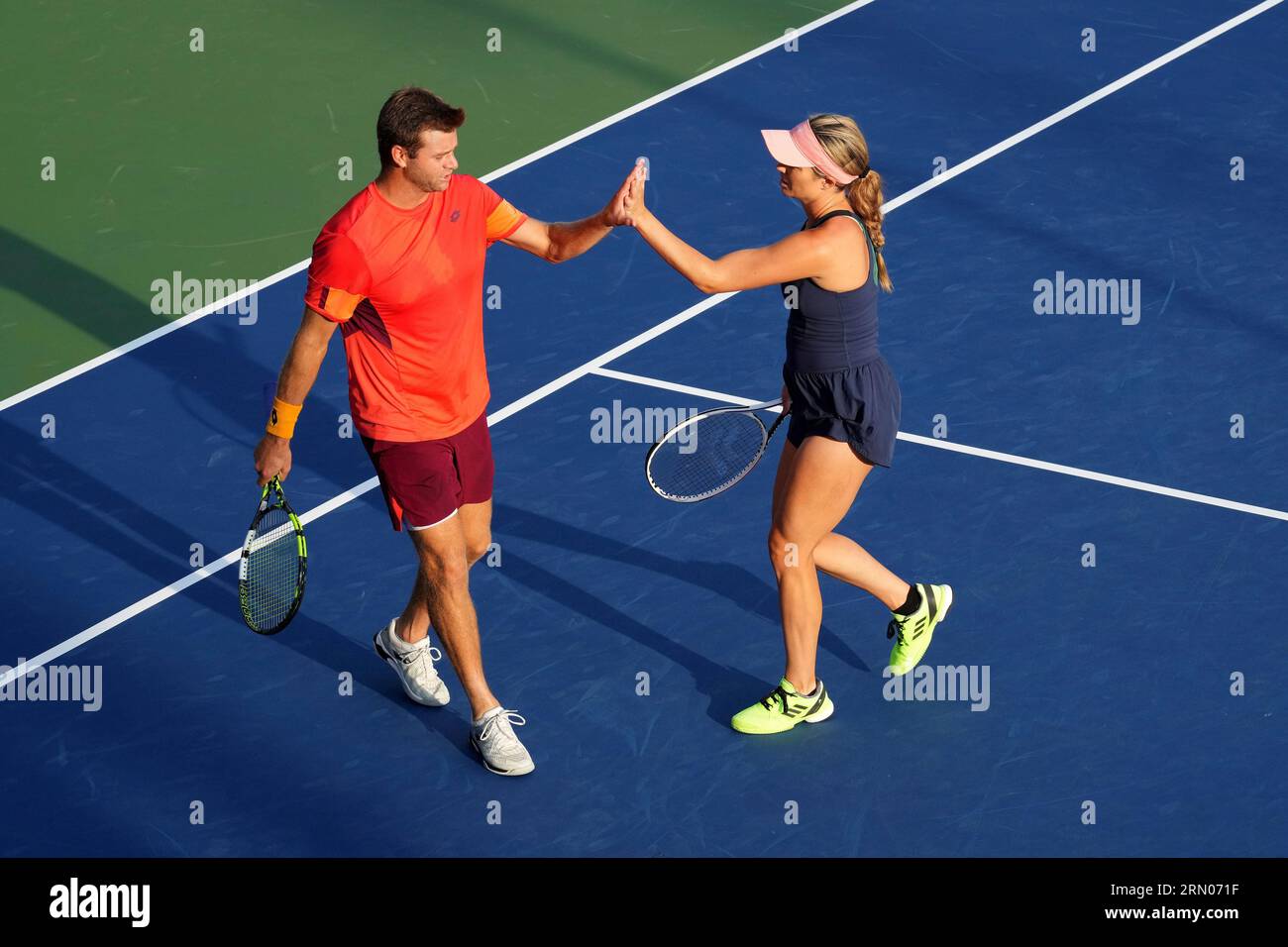 Danielle Collins and Ryan Harrison high five during a mixed doubles ...
